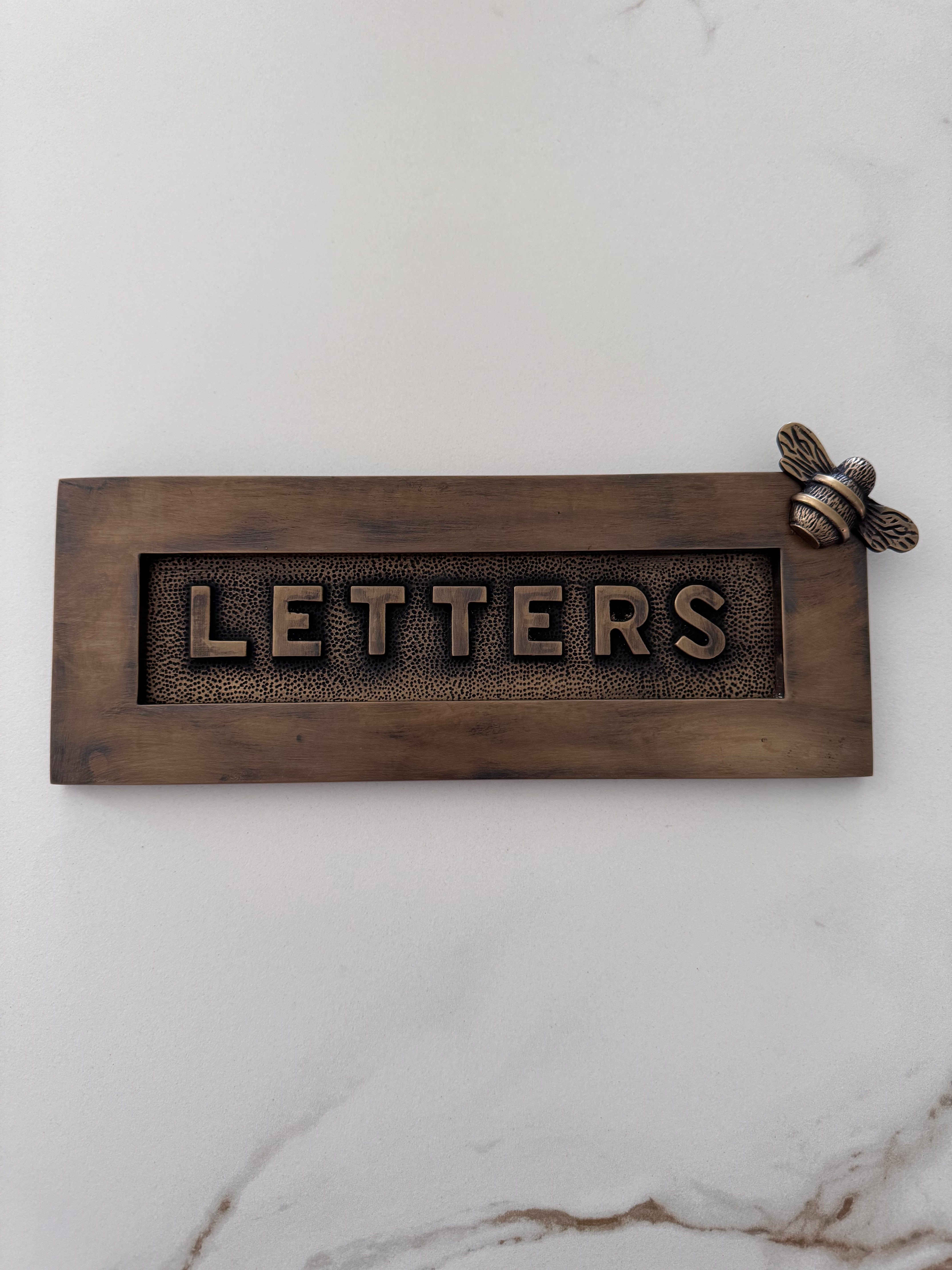 Wall mounted post box with bee design